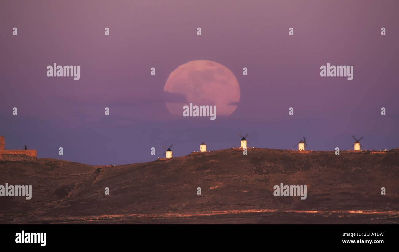 Amazing scenery of majestic full Moon over valley with windmills in ...