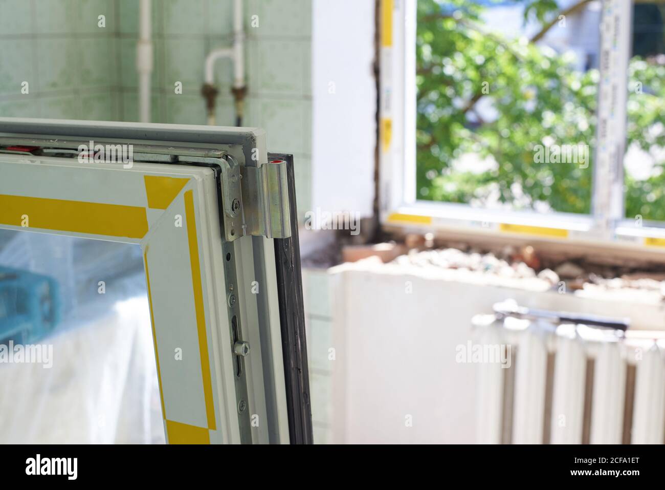 Part of the new plastic window in the foreground, installation of a ...