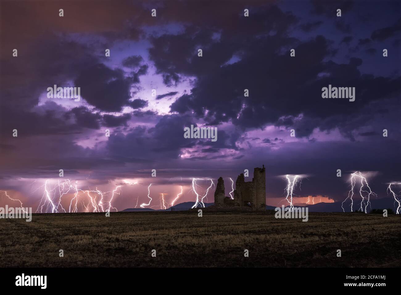 Amazing scenery of lightning storm on colorful cloudy sky over ruined ...