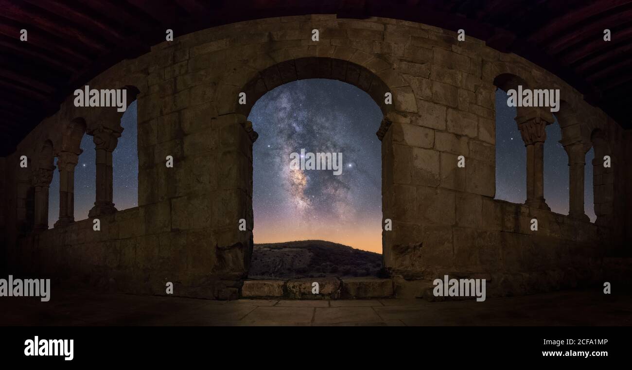 Fish eye view of Milky Way galaxy through arch entrance of old ruined ...
