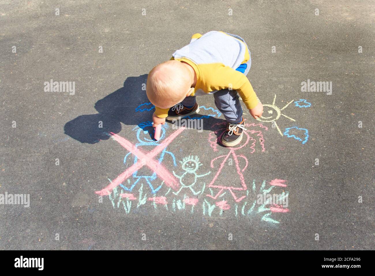 Children's drawing with colorful chalk on the asphalt, family with no ...