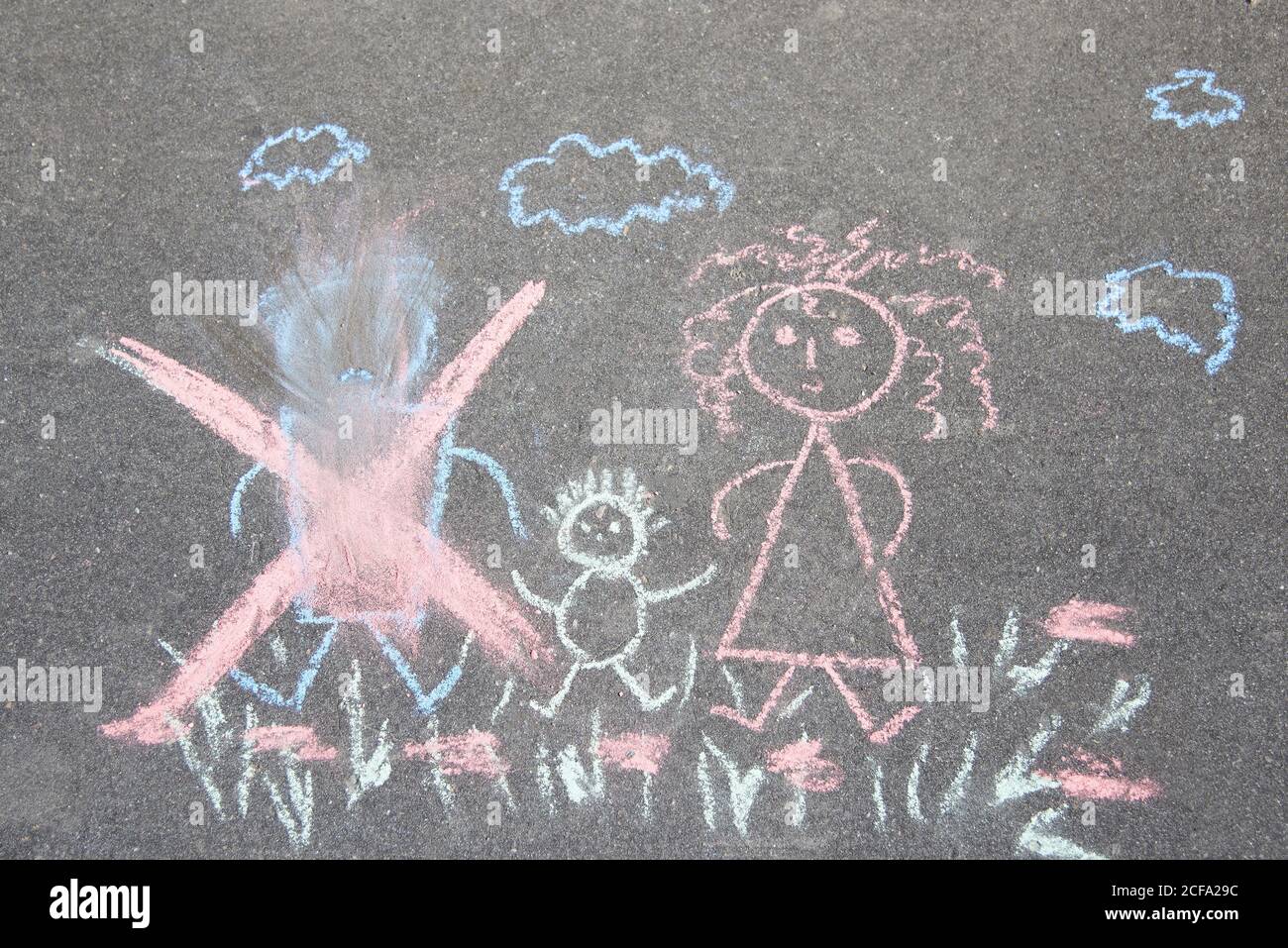 Children's drawing with colorful chalk on the asphalt, family with no ...