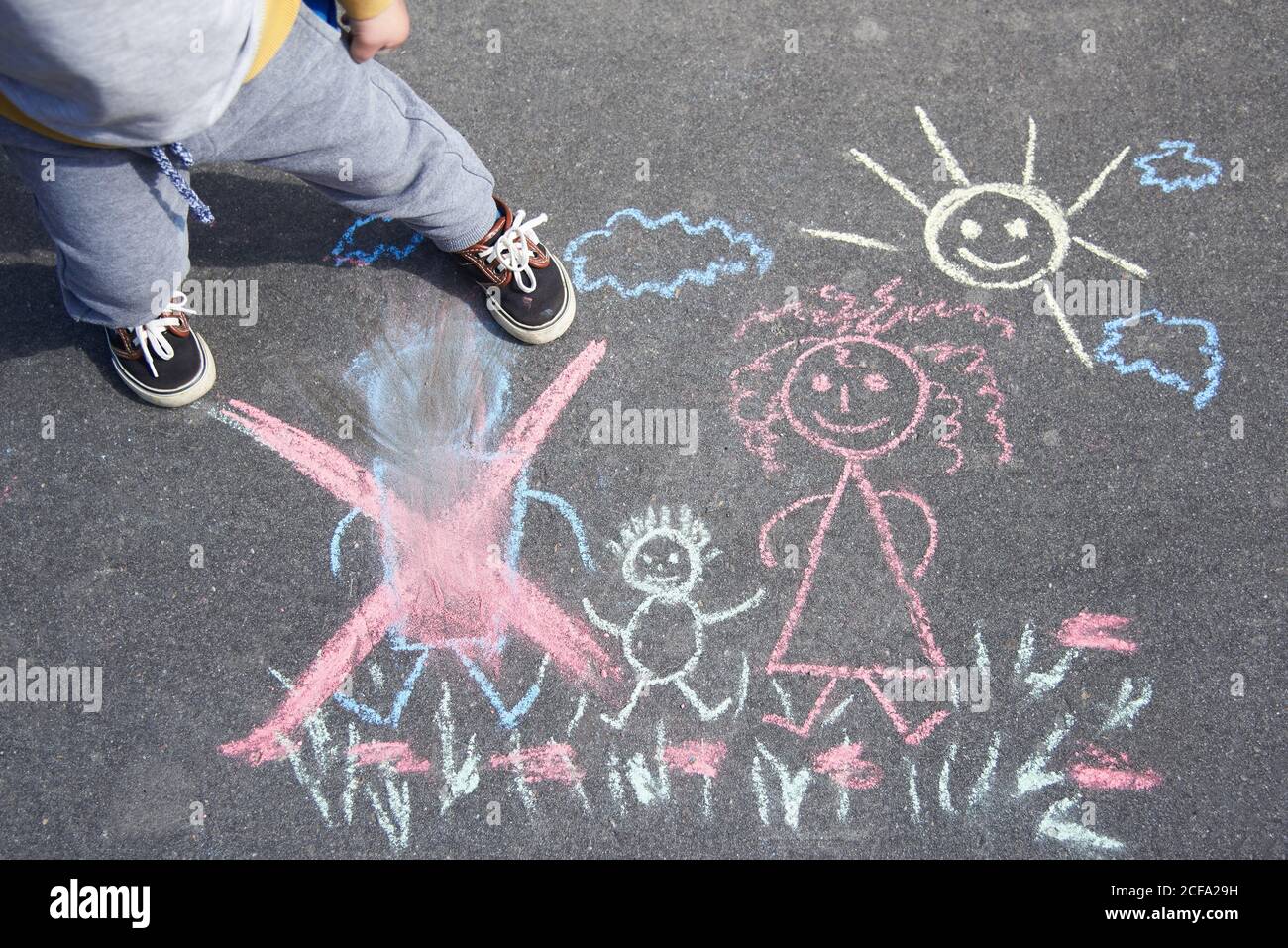 Children's drawing with colorful chalk on the asphalt, family with no ...