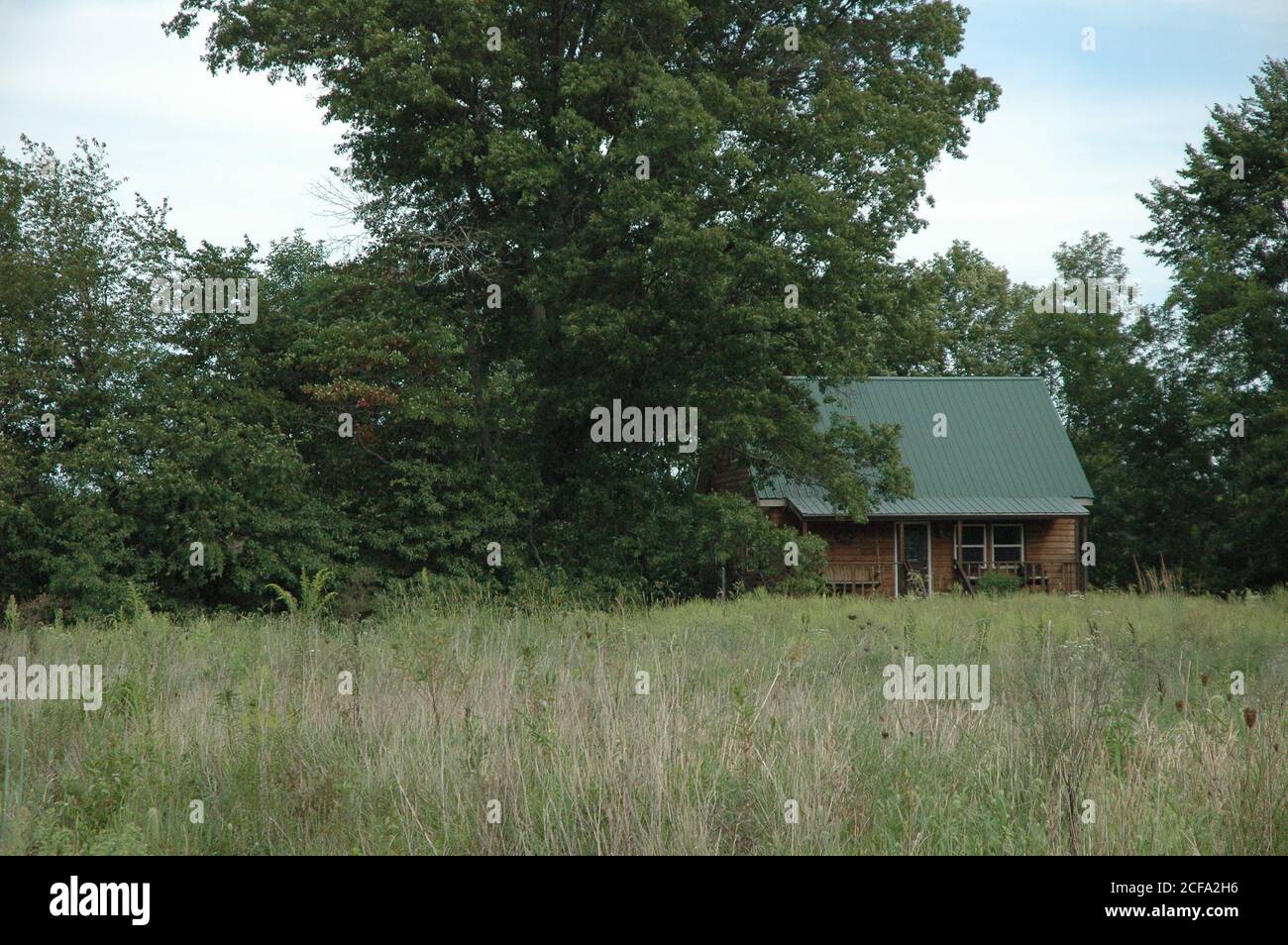 Cabin at the edge of a field Stock Photo - Alamy