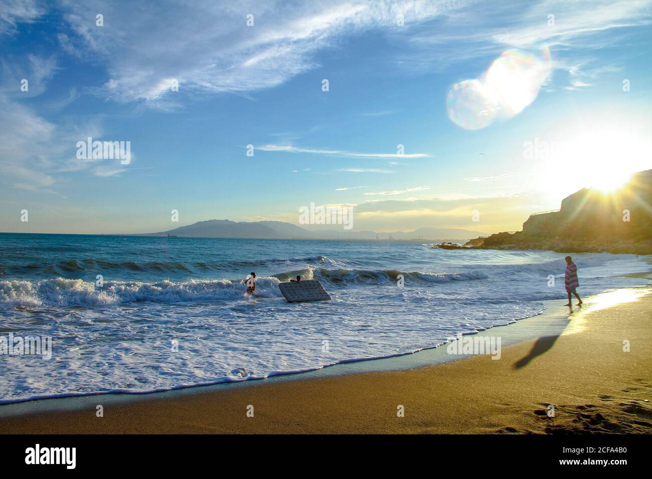 Majestic wavy seascape view with people on the beach Stock Photo - Alamy