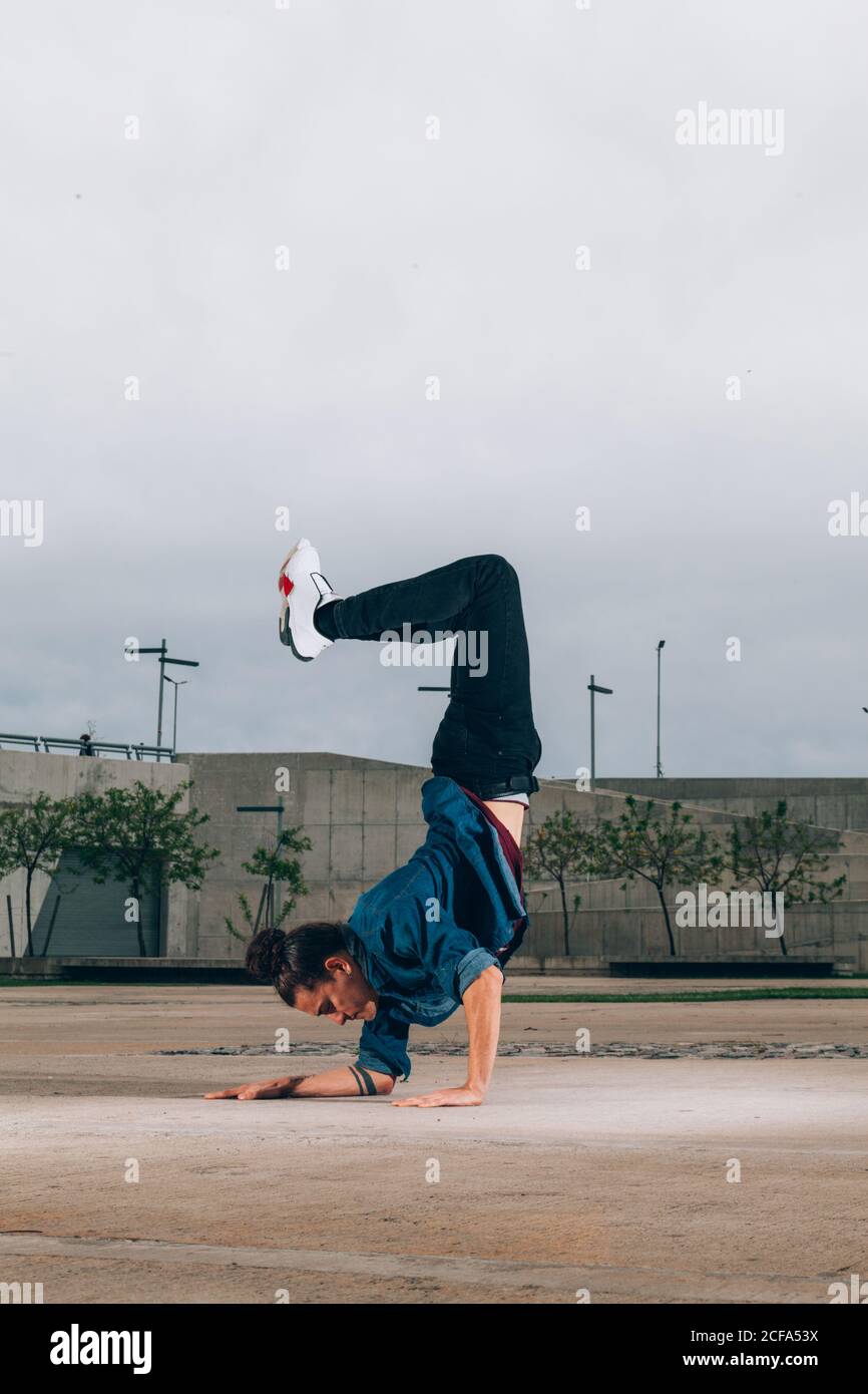 Skillful break dancer performing handstand while moving Stock Photo - Alamy