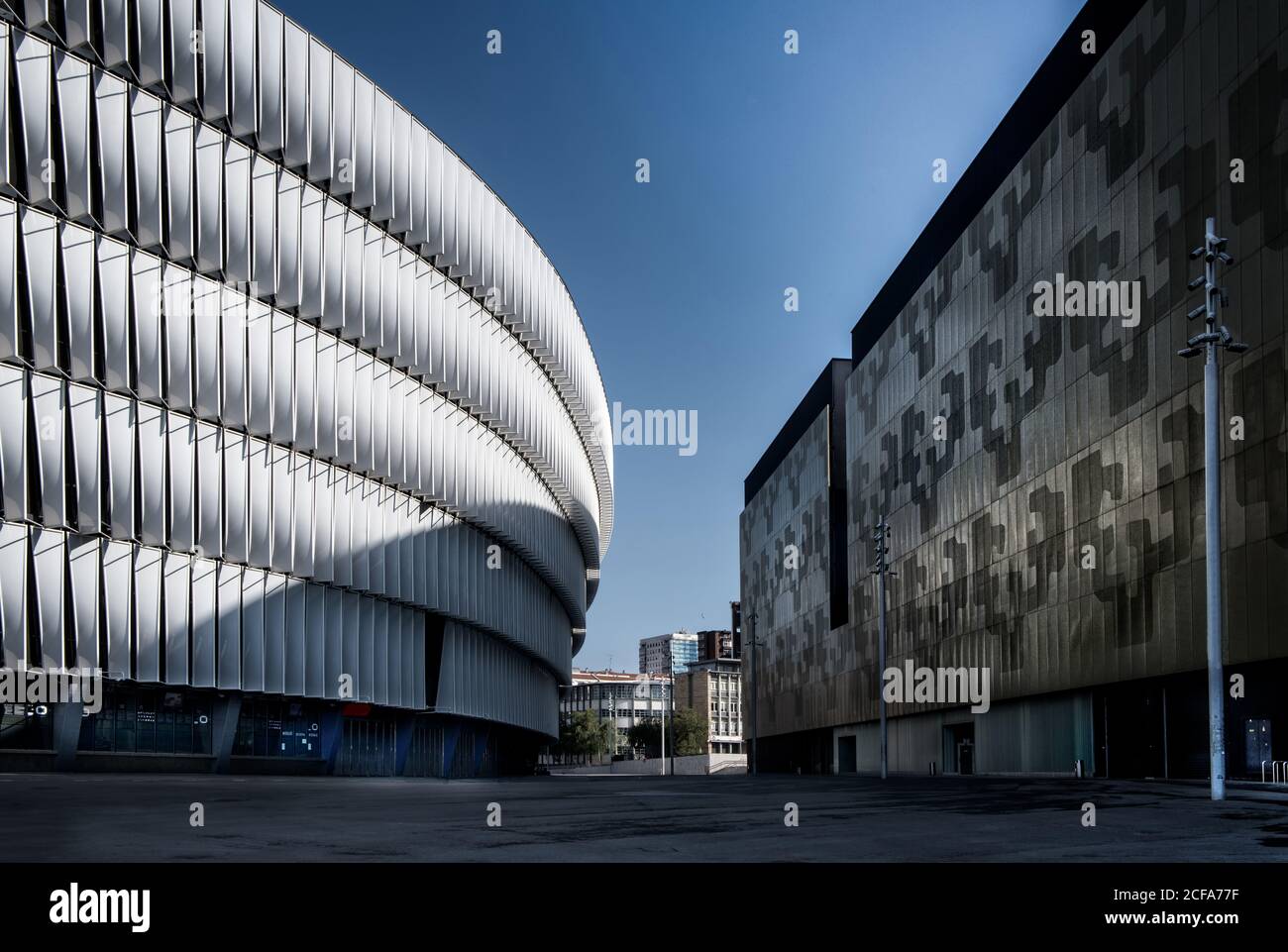 Round and rectangular buildings with massive facades with large gray ...