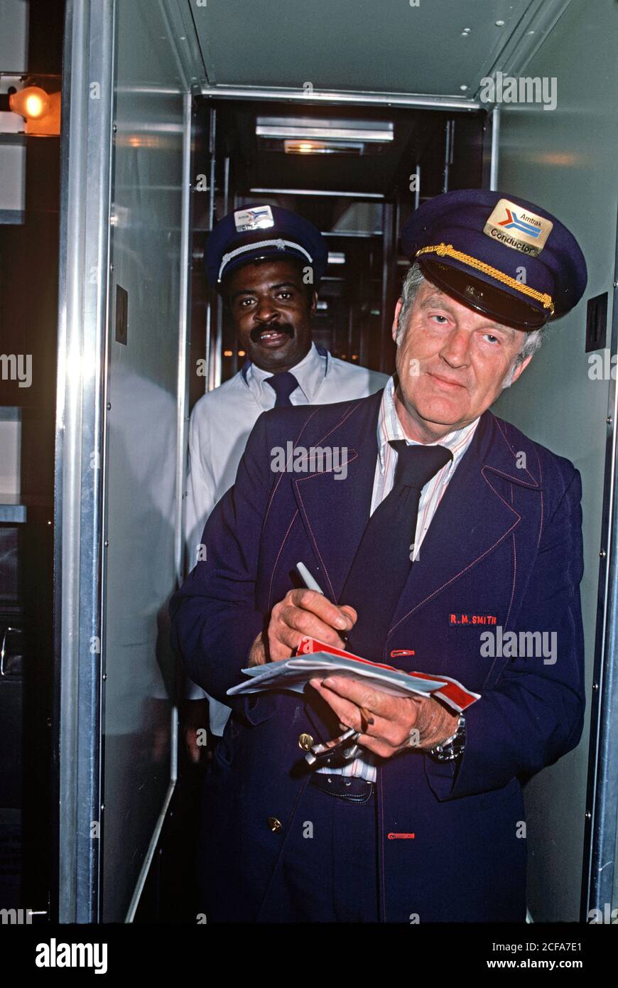 AMTRAK TRAIN CONDUCTOR WITH ATTENDANT, USA, 1970s Stock Photo - Alamy