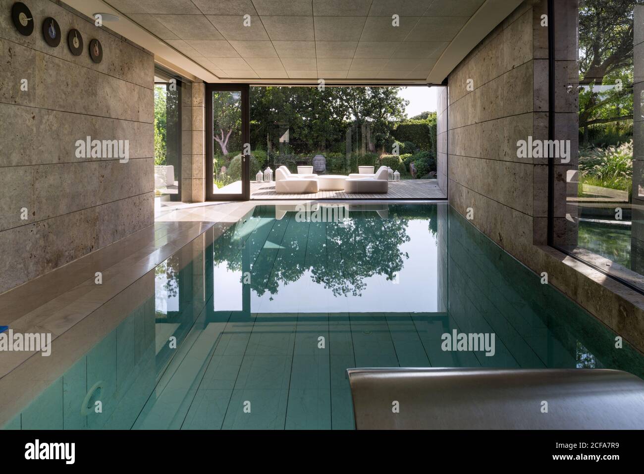 Interior of spacious pool with clear water surrounded by stone and ...