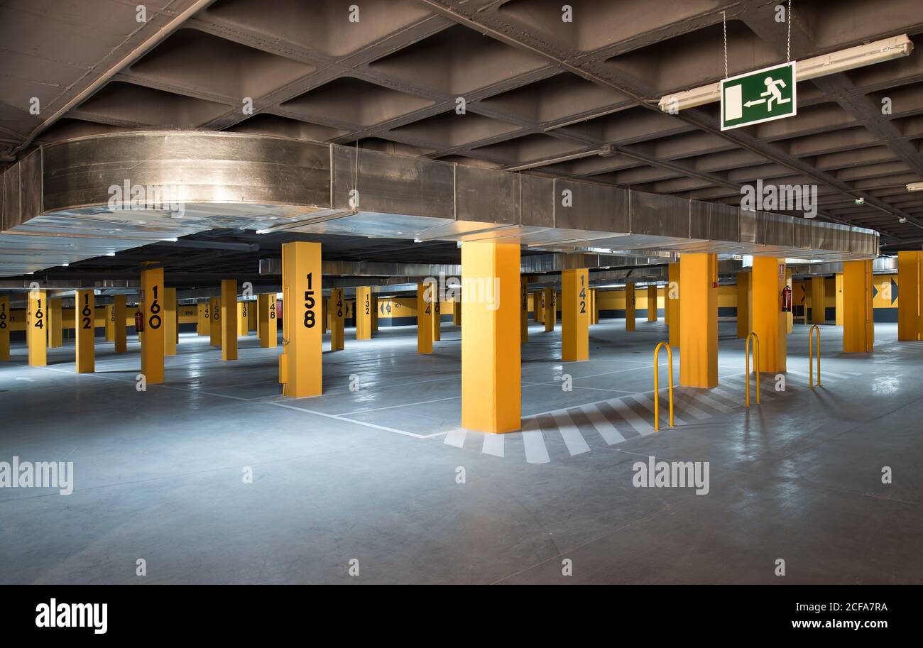 Modern parking lot with yellow stone columns and concrete floor located ...