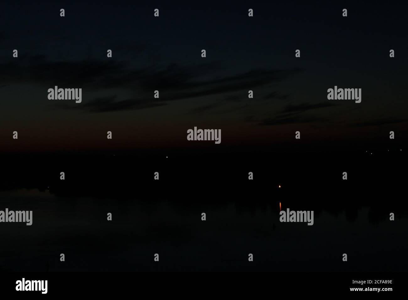 Sunset over the river blue and red sky stars and trees forest reflected ...