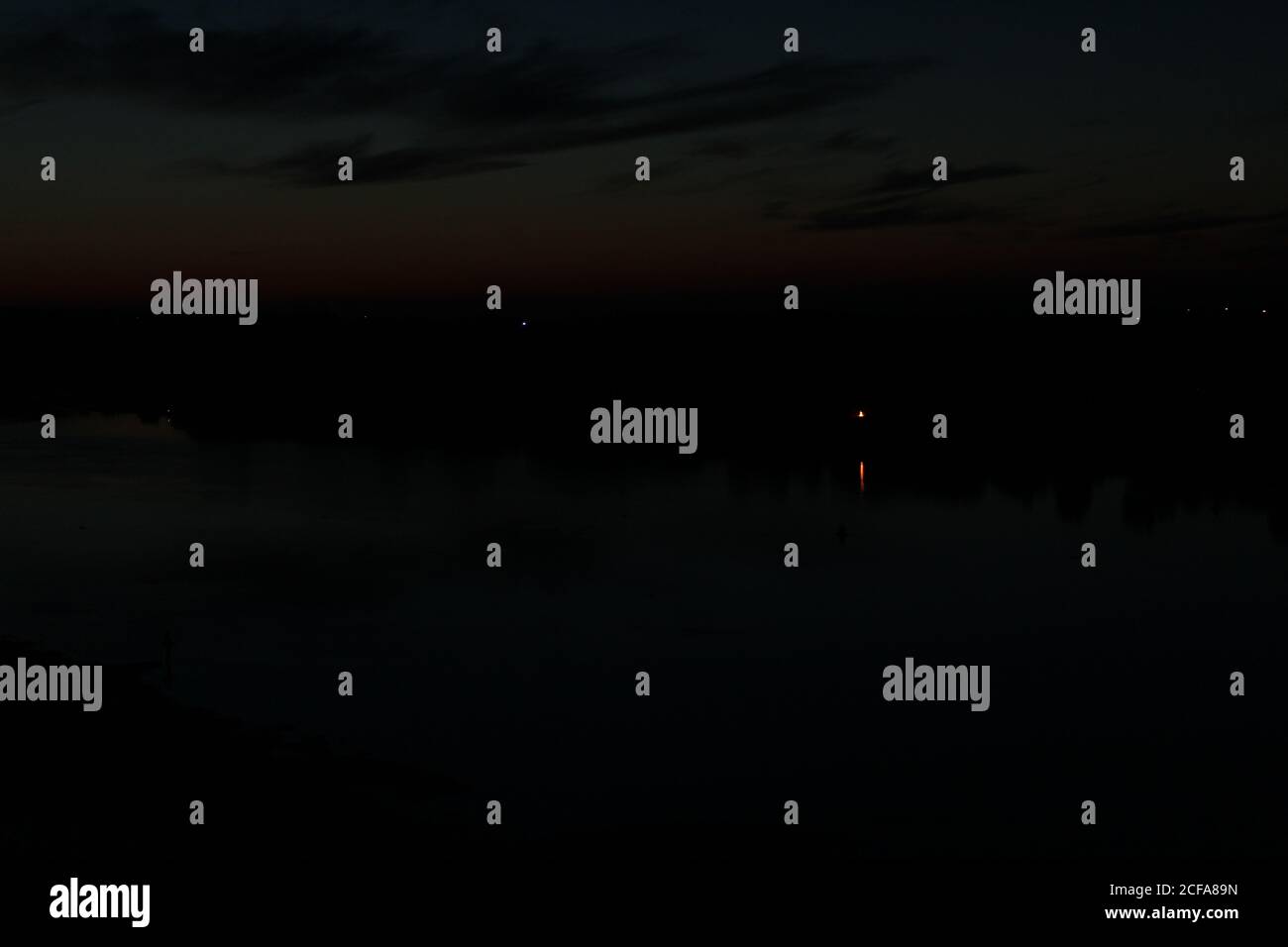 Sunset over the river blue and red sky stars and trees forest reflected ...