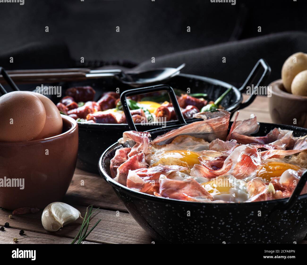 Pan with fried eggs with traditional Spanish iberian ham served on ...