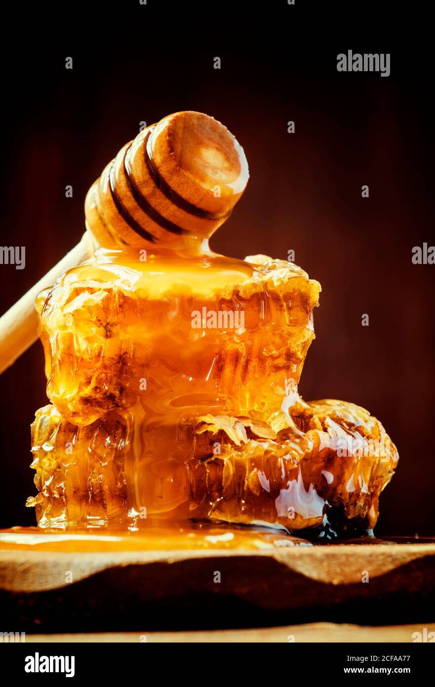 Honey comb with dipper, vintage wooden background, shallow depth of ...