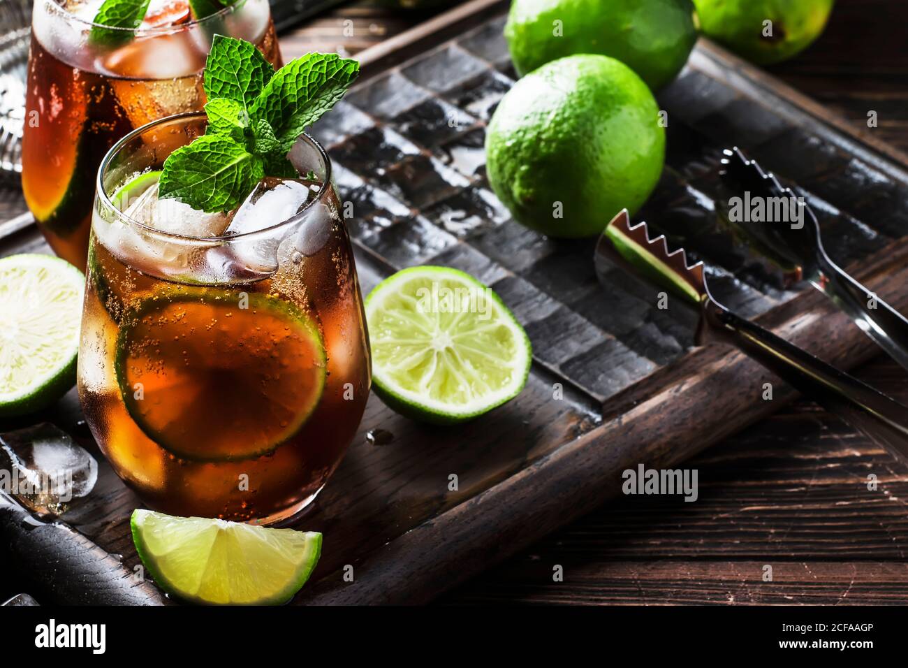 Cuba libre alcohol cocktail with golden rum, lemon juice, cola, lime ...