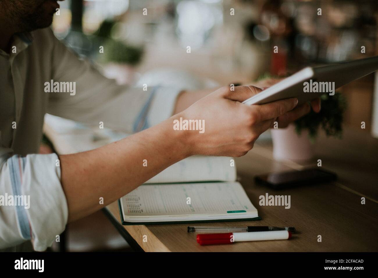 Person taking notes in a notebook while working from home Stock Photo ...