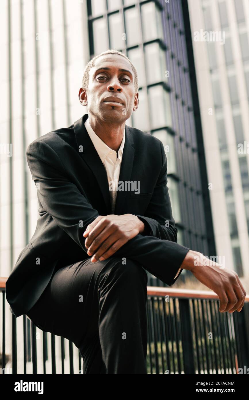 Elegant businessman leaning railing city hi-res stock photography and ...