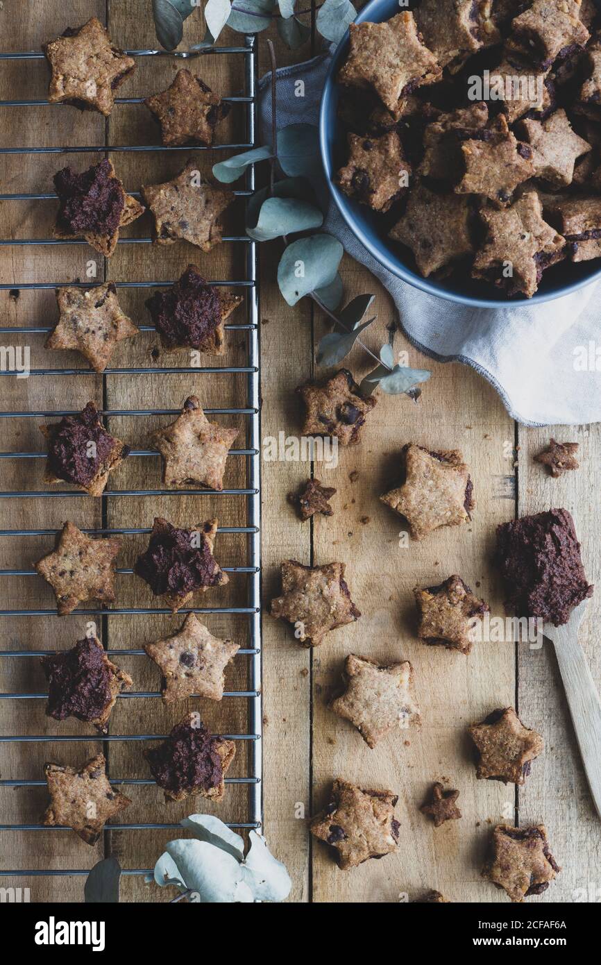 Top view of pieces of cookies on grill from oven with spoon of ...
