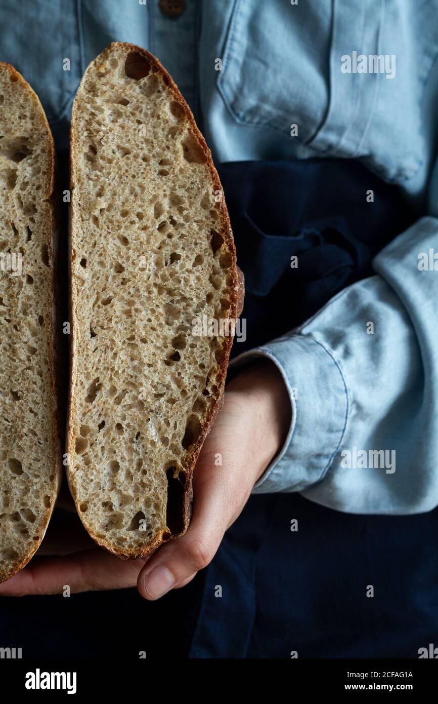 anonymous crop hand Woman in apron holding slice homemade sourdough ...