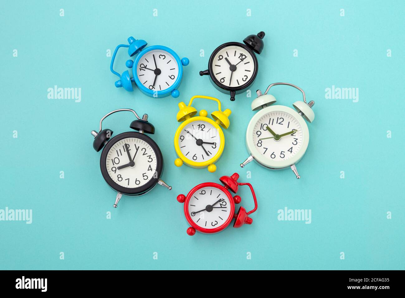 Time concept, clocks with various time and color on blue background ...