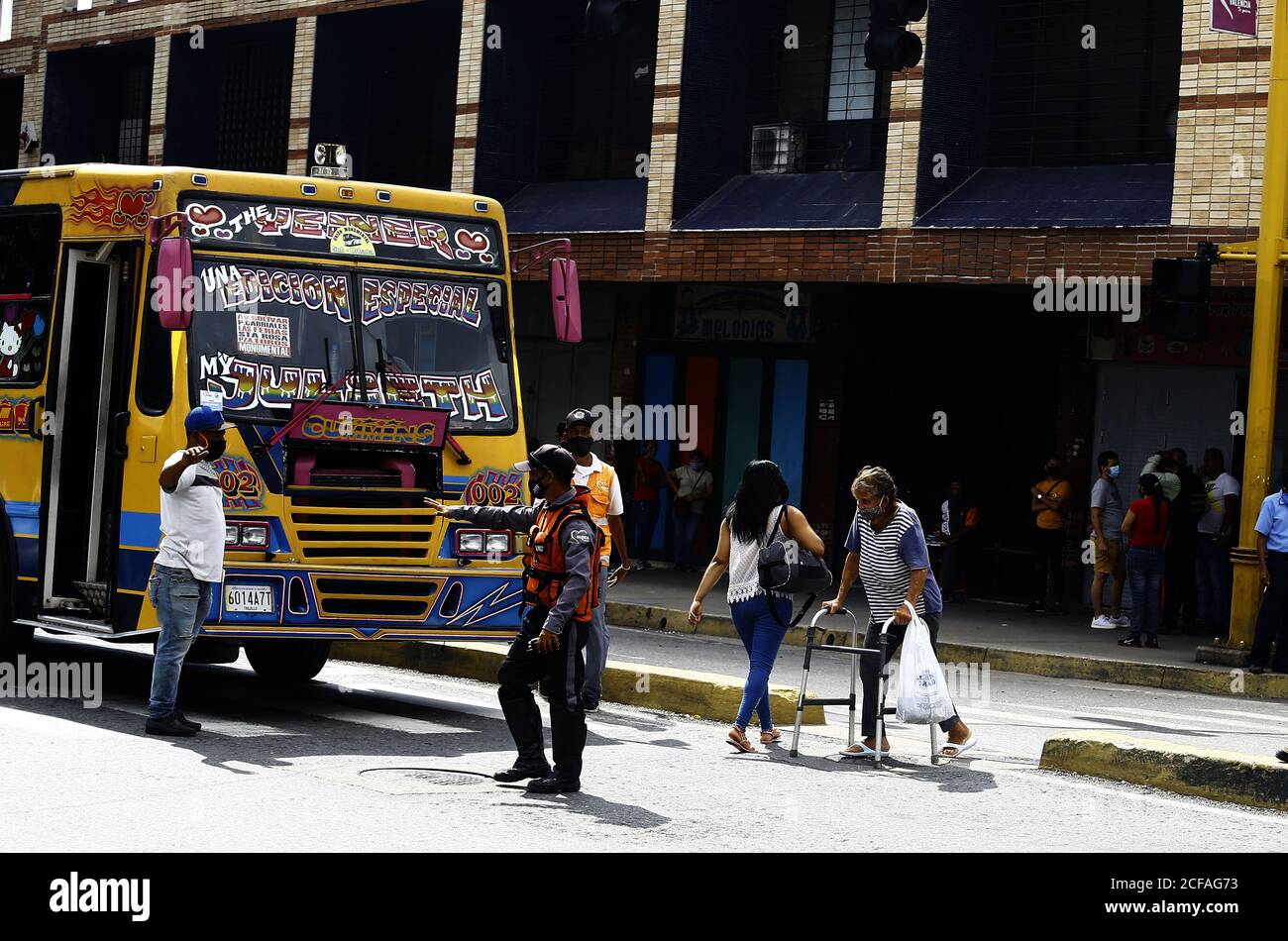 Helping elderly cross street hi-res stock photography and images - Alamy