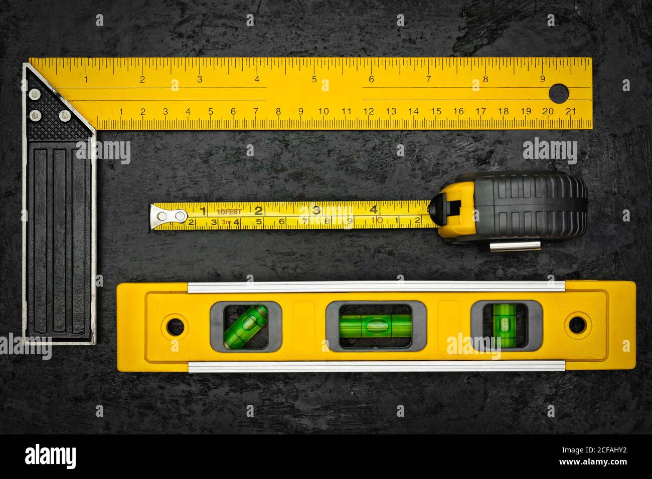 Set of measuring tools on a textured black metallic background Stock ...