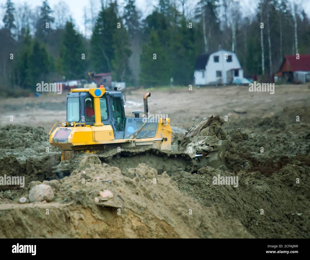 Crawler bulldozer (tractor-mounted dozer). Preparation of the site for ...