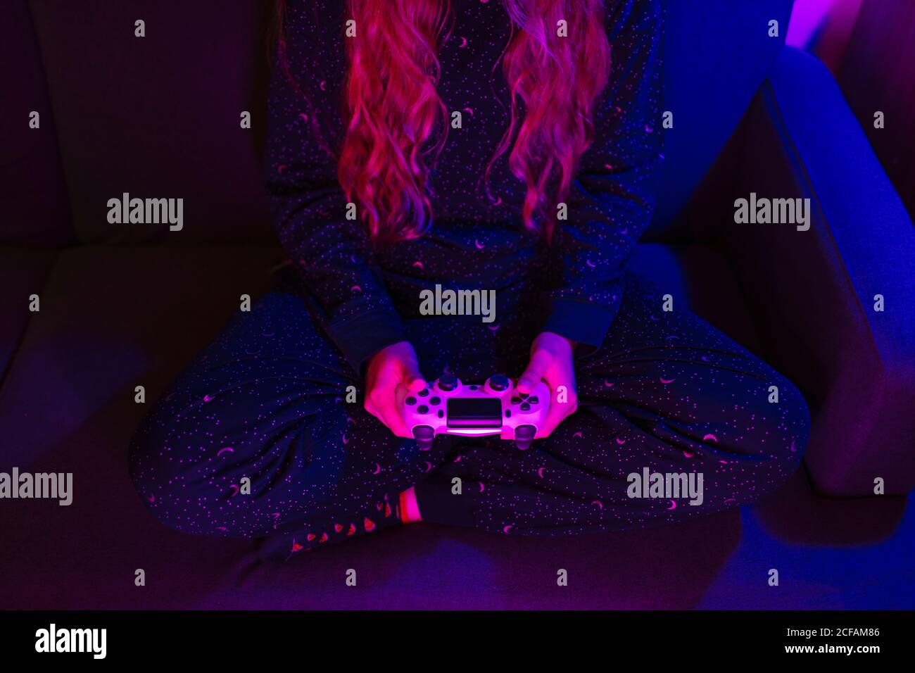 Front view of a blonde girl with a video game controller and colorful ...