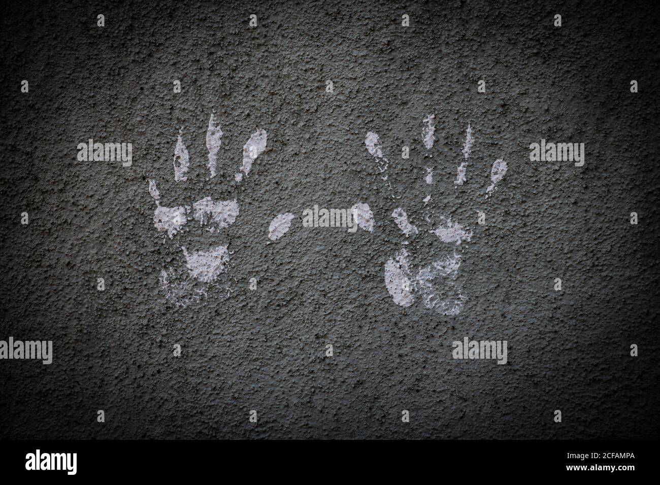 White hand prints on a cement wall with a dark vignette border Stock ...