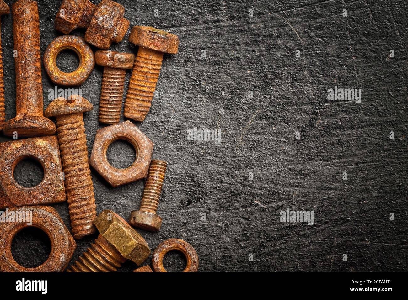 Nuts,bolts and nails on a textured metallic background with space for ...