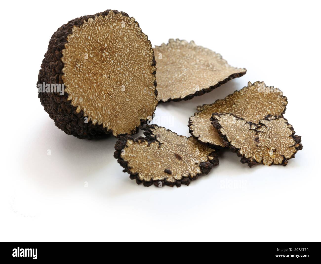 sliced fresh black truffle isolated on white background Stock Photo - Alamy