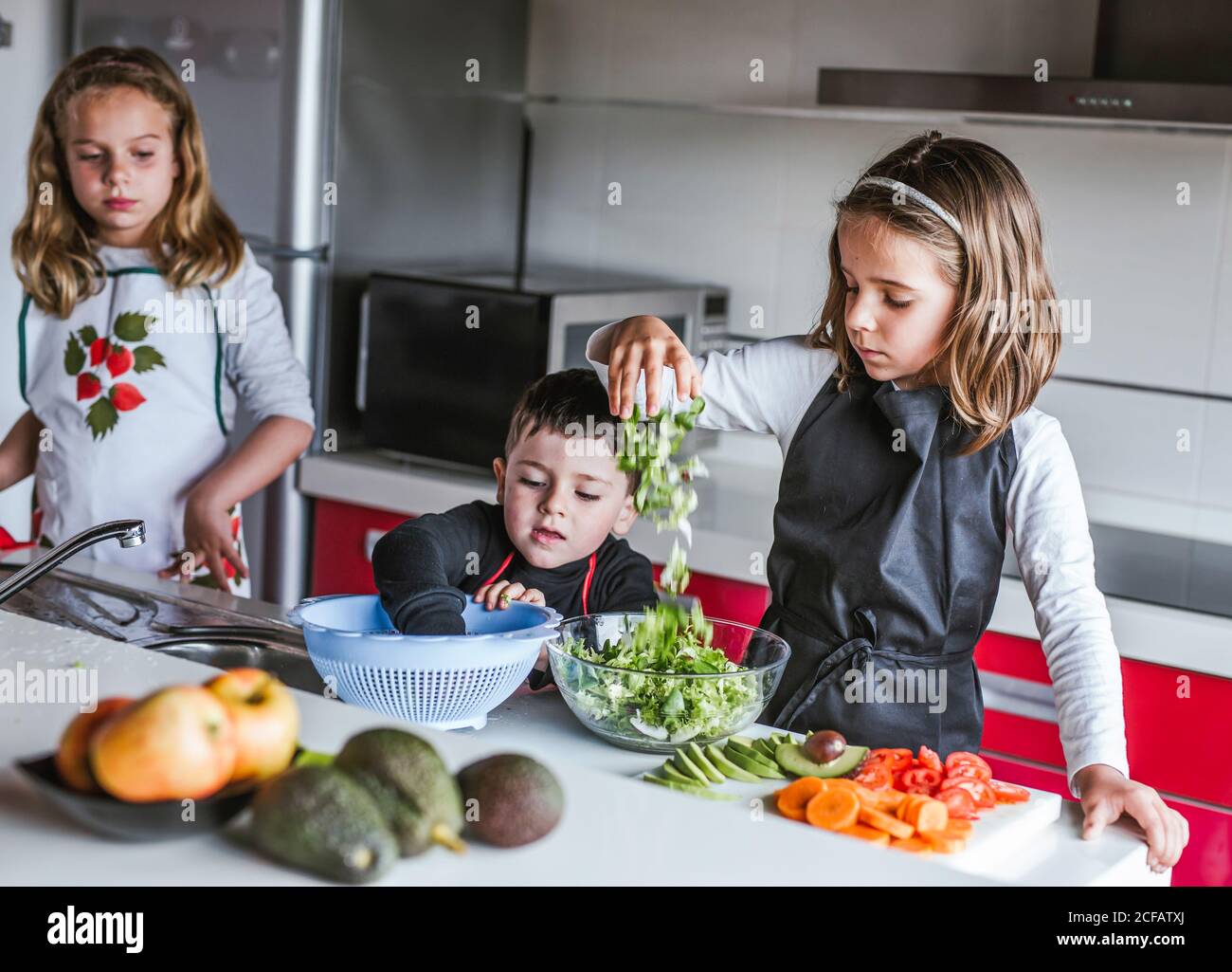 Little girls and boy Kids playing while while cooking healthy salad in ...