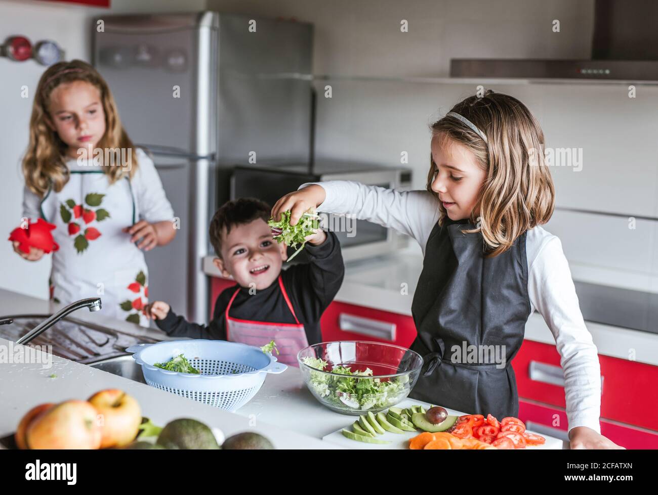 Little girls and boy Kids playing while while cooking healthy salad in ...