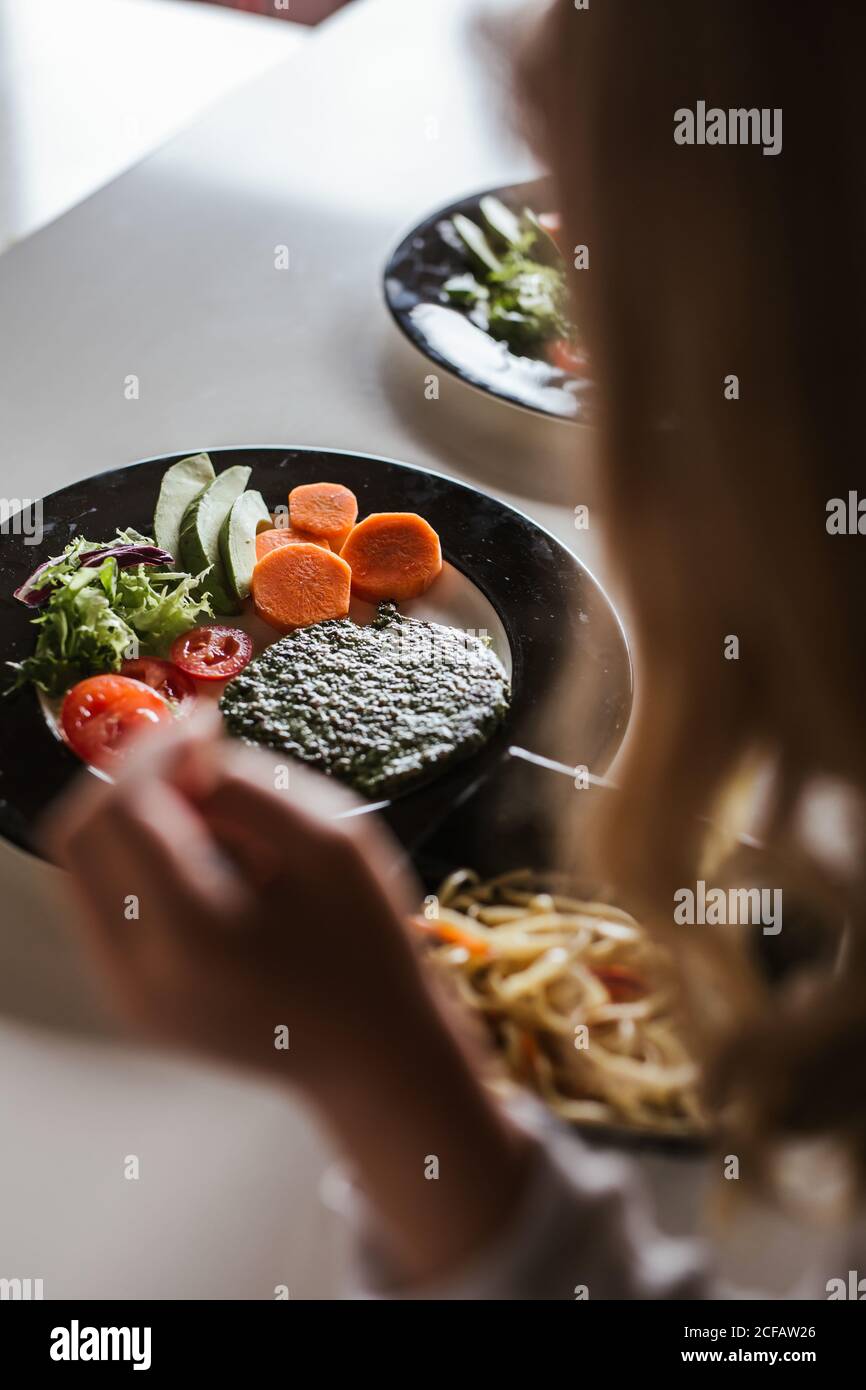 First person view of anonymous girl eating vegetarian cutlets and ...