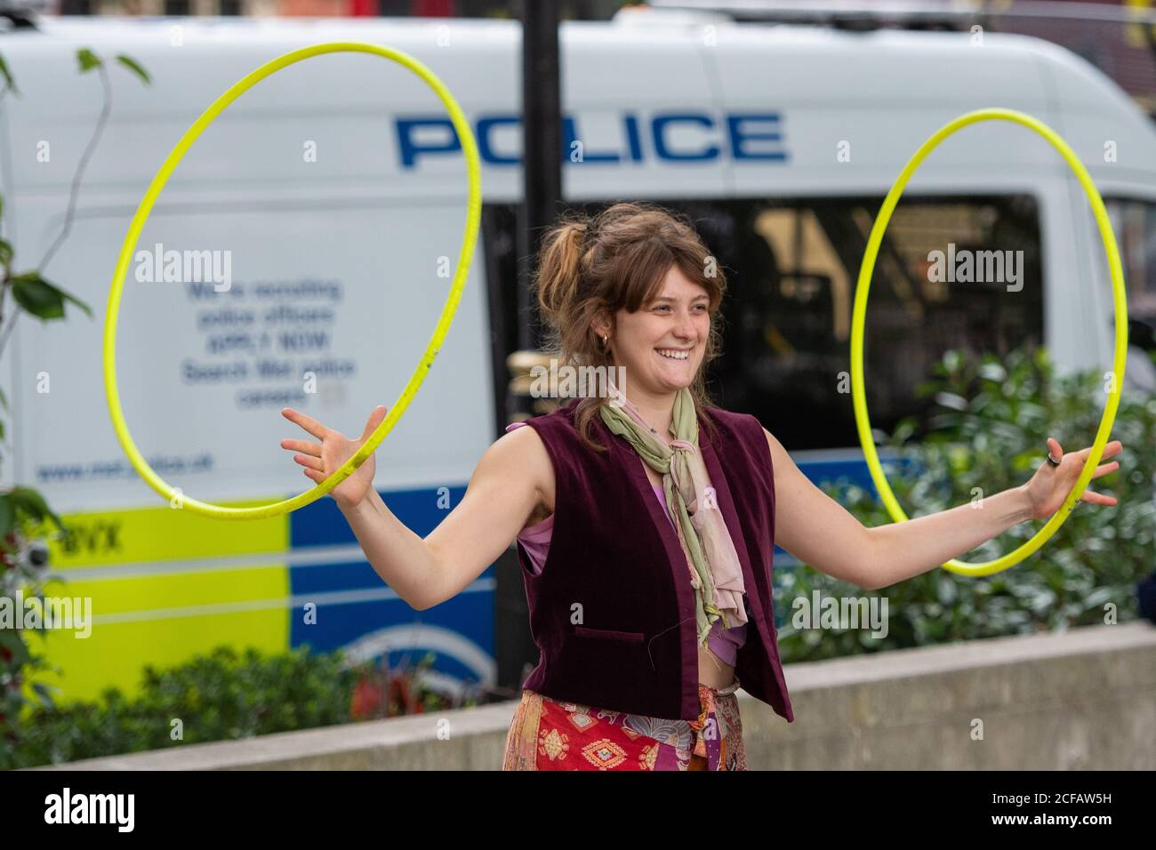 A protestor juggles hula hoops at an Extinction Rebellion protest in ...