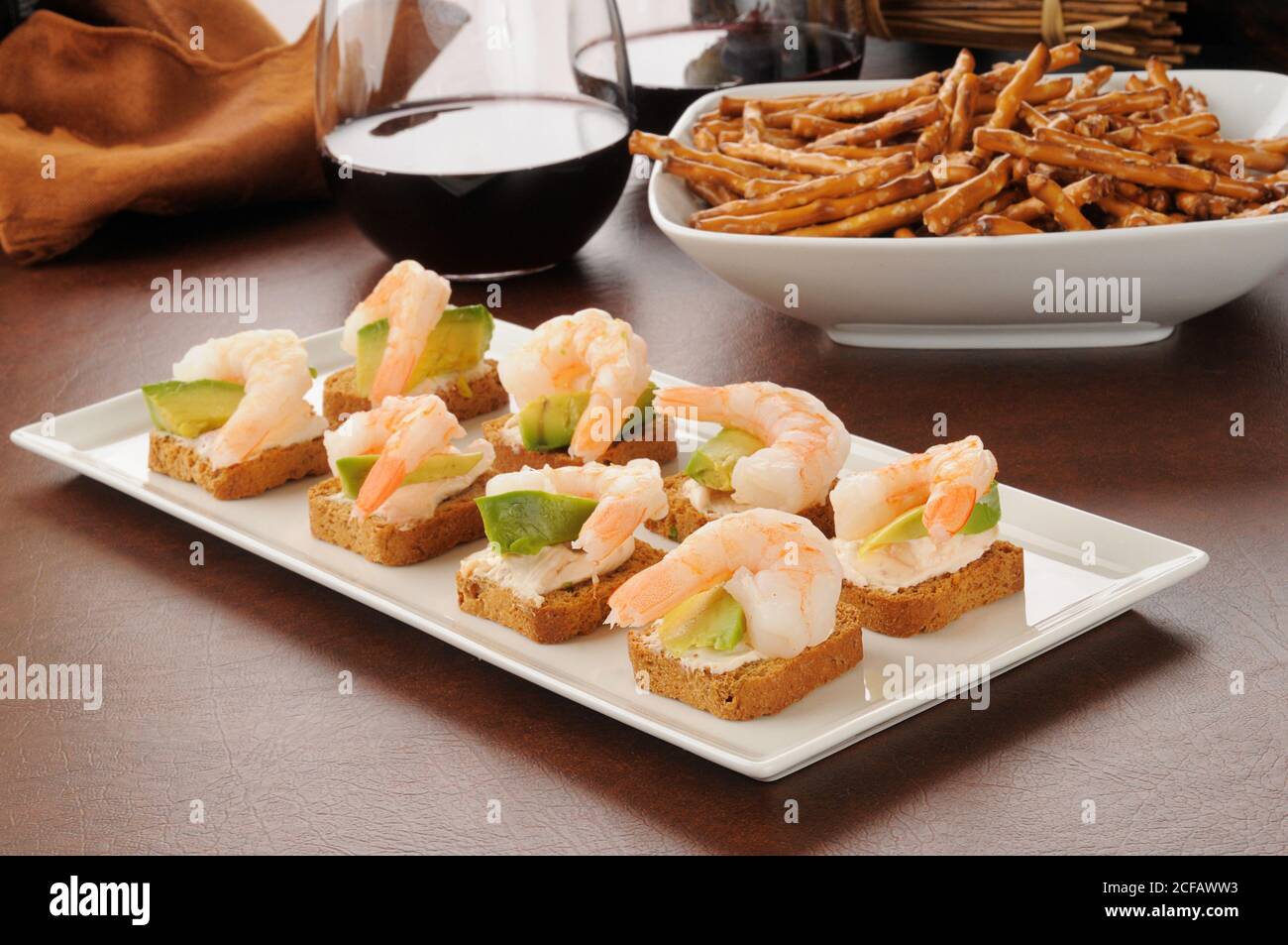 A serving tray of shrimp canapes on mini wheat toasts with avocado ...