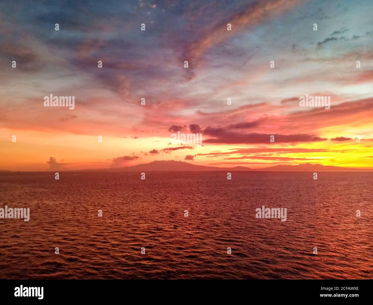 sunset in manila bay orange sky Stock Photo - Alamy