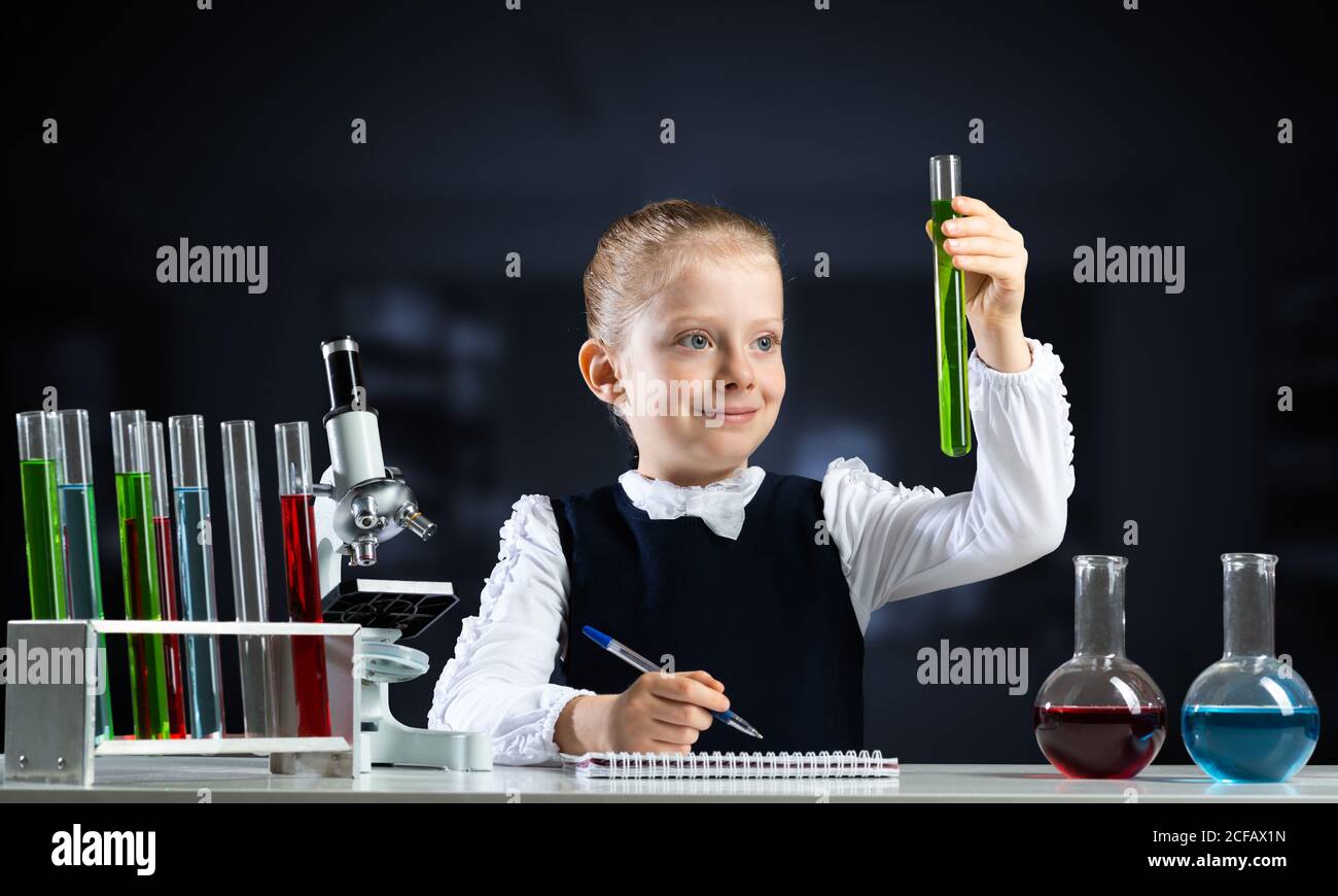 Little girl scientist examining test tube Stock Photo - Alamy
