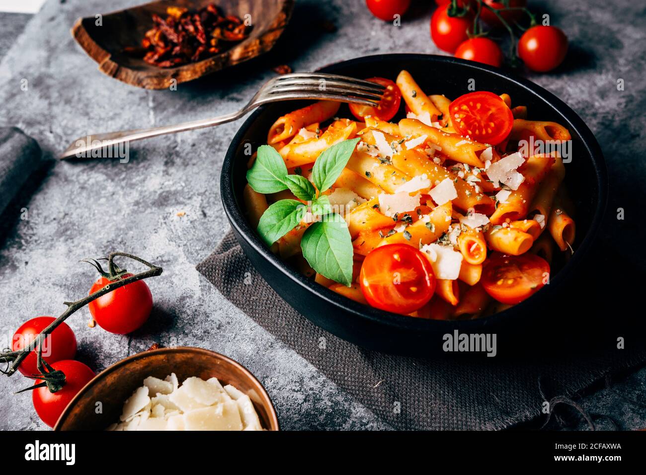 From above delicious pasta decorated with ripe cherry tomatoes and ...