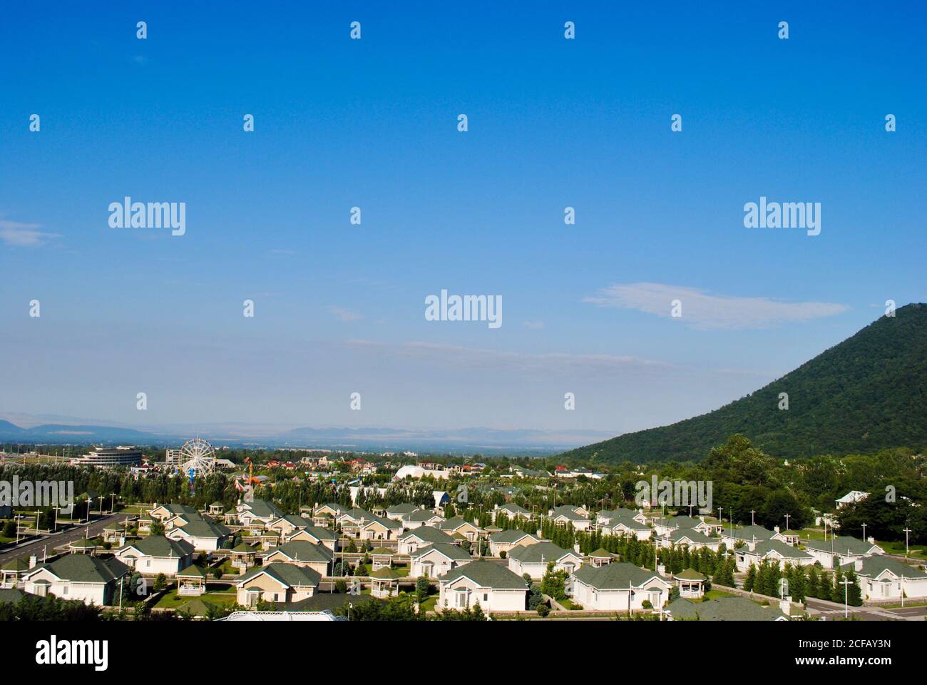 A distant view of a land/city scape of a new urban town at the foot of ...