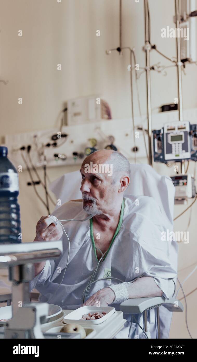 Older man admitted to a hospital room due to health problems Stock ...