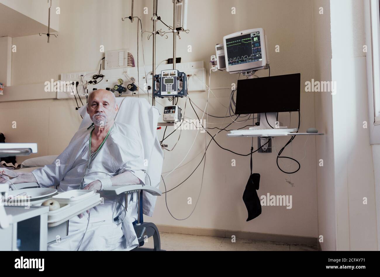 Older man admitted to a hospital room due to health problems Stock ...