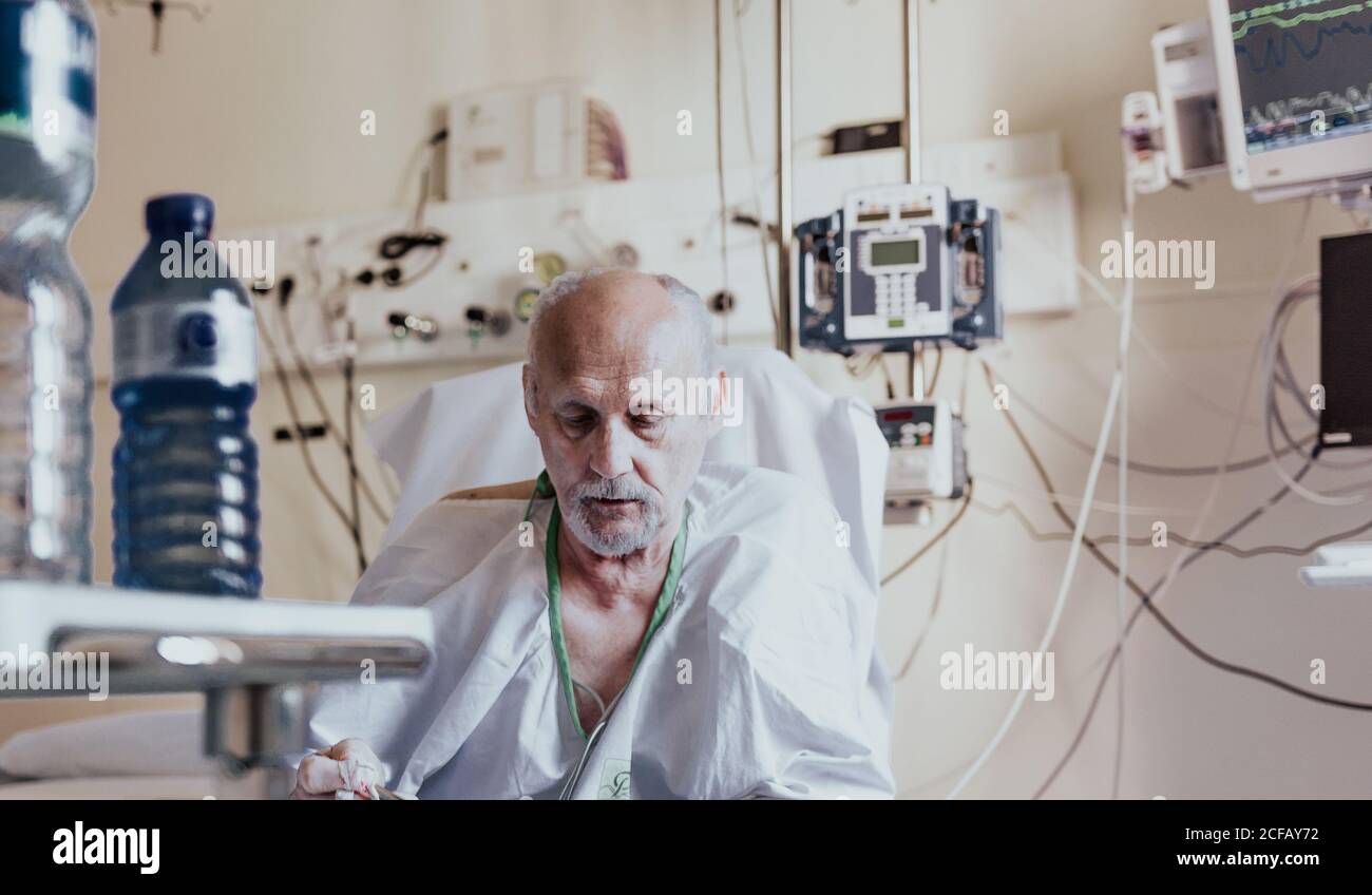 Older man admitted to a hospital room due to health problems Stock ...