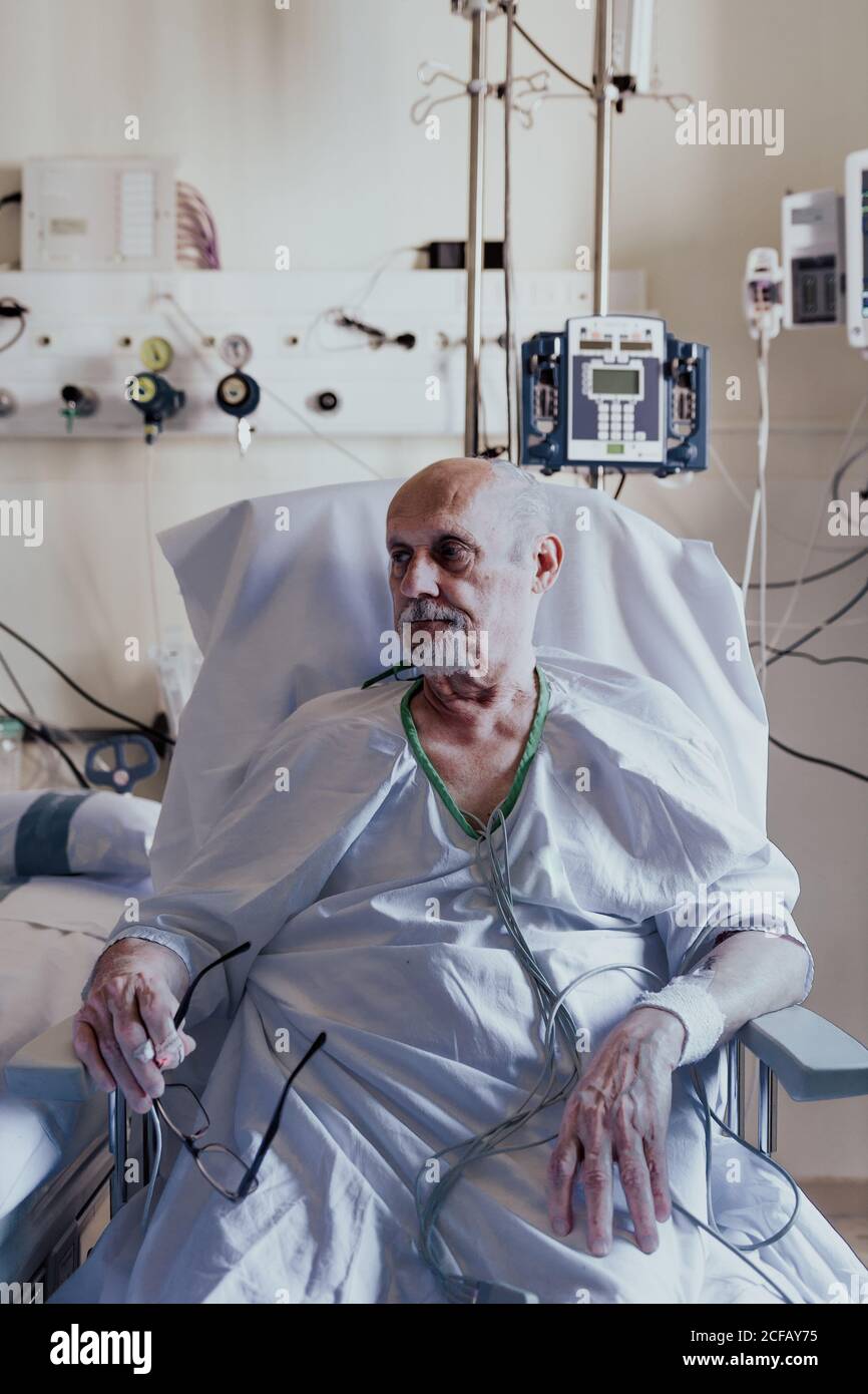 Older man admitted to a hospital room due to health problems Stock ...