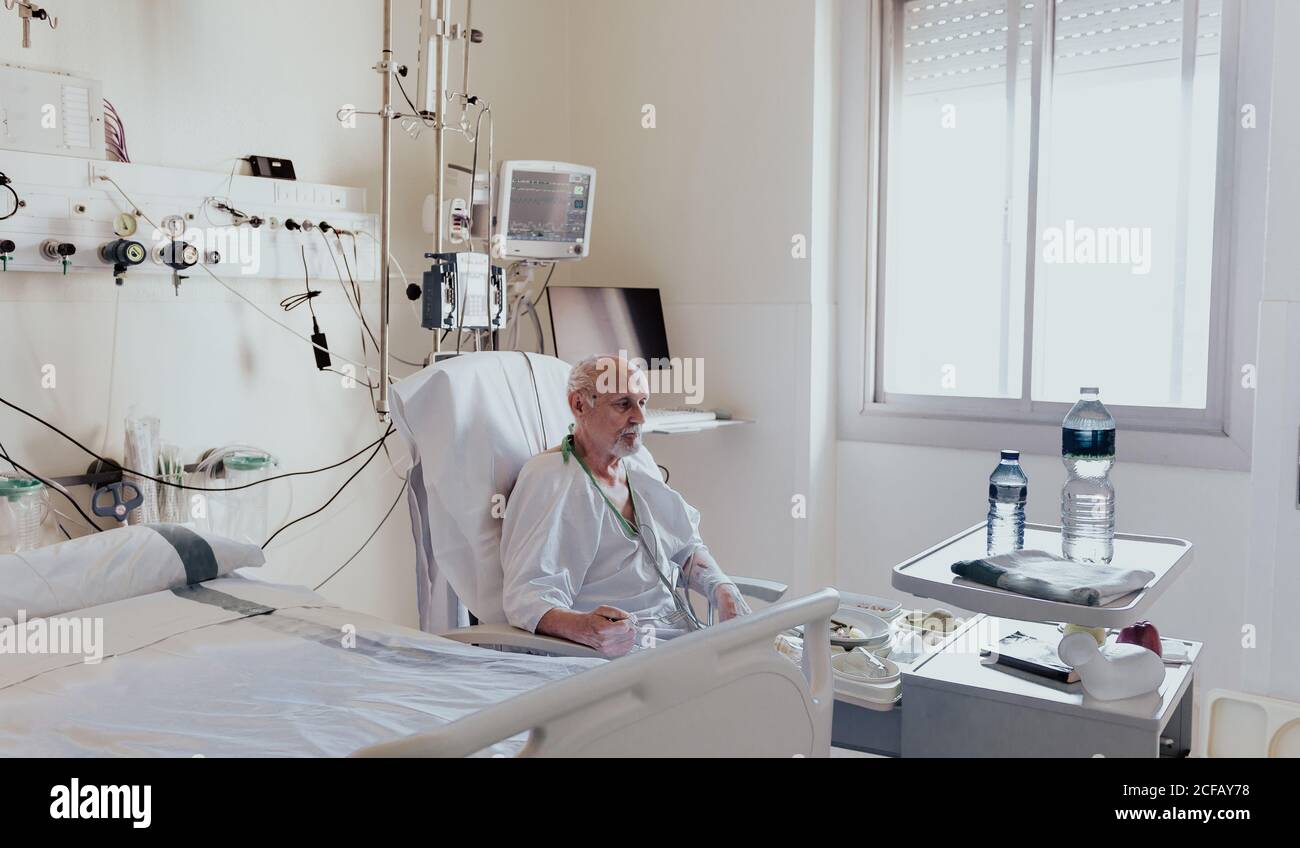 Older man admitted to a hospital room due to health problems Stock ...