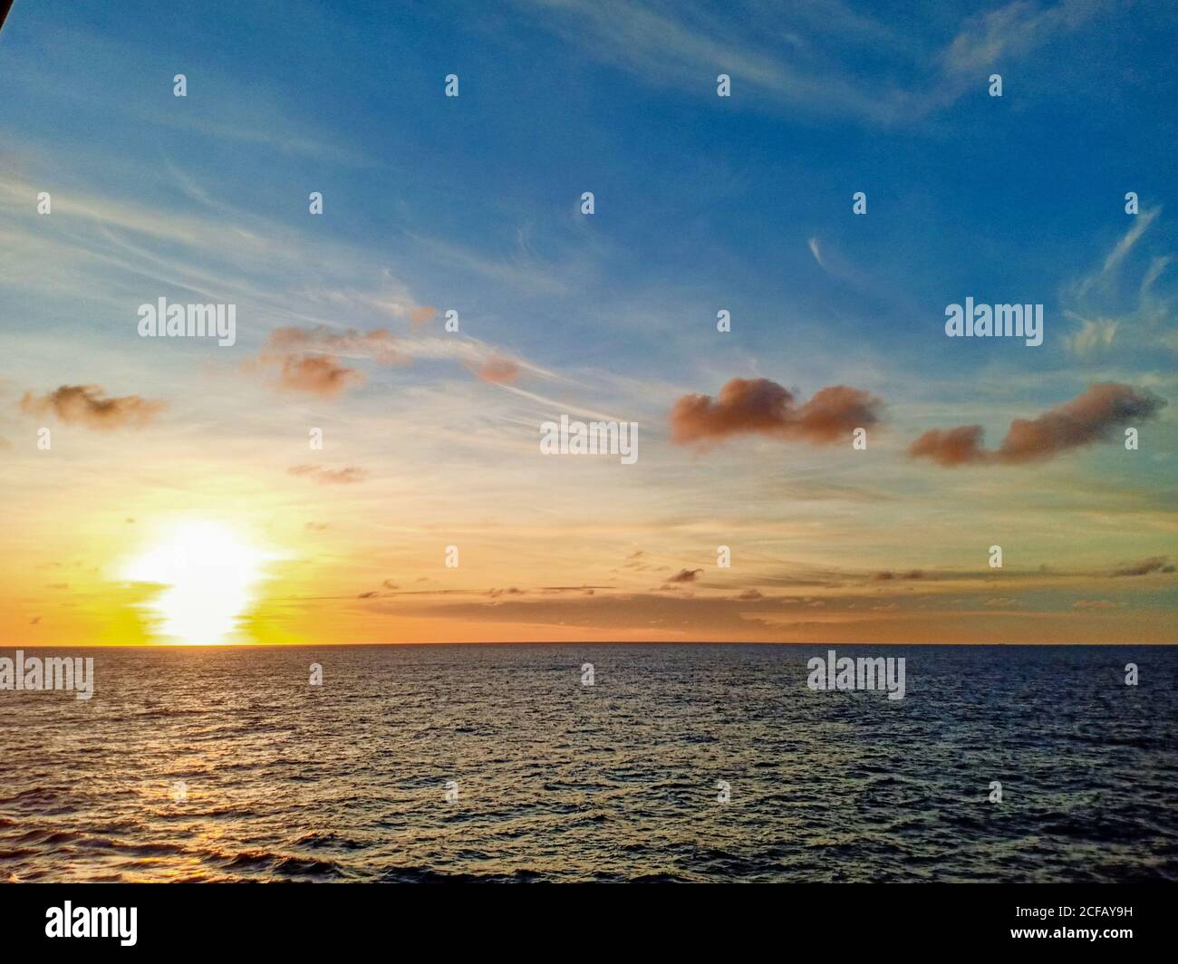 sunset and yellow sky and ocean Stock Photo - Alamy