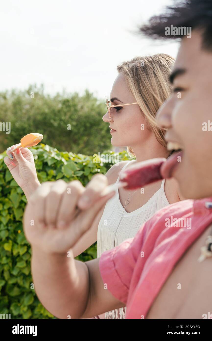 Friends eating ice cream while talking on the terrace of a bar Stock ...