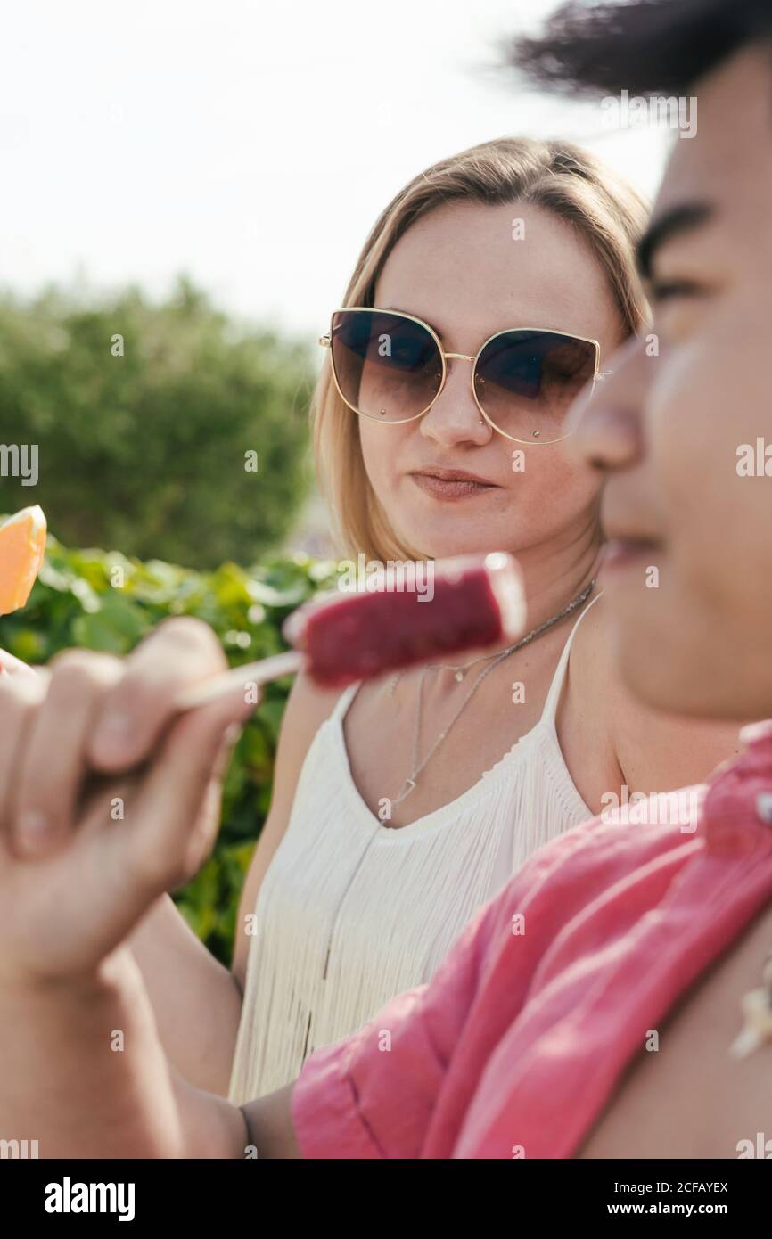 Friends eating ice cream while talking on the terrace of a bar Stock ...
