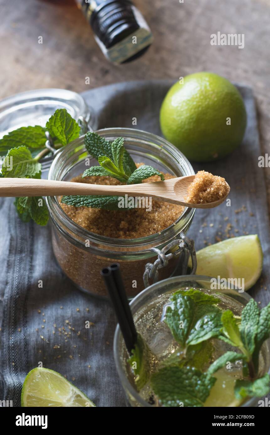 Overhead fresh limes and peppermint leaves placed on napkin and table ...