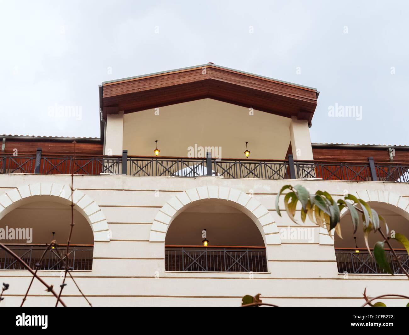 Top of the building with arched balconies with a triangular roof and ...